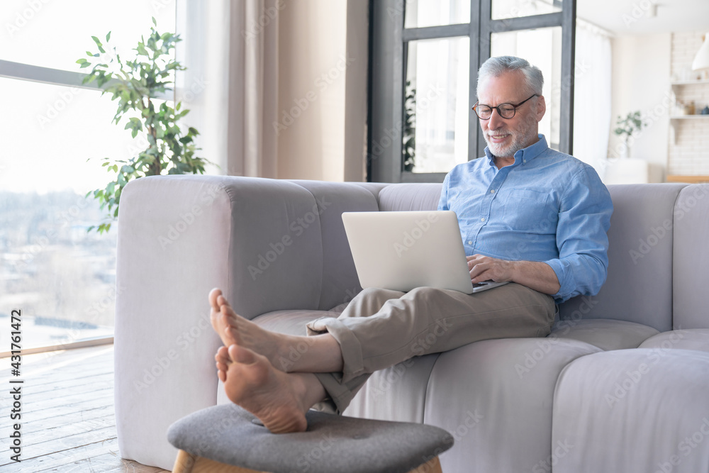 Relaxed old mature elderly senior man working on laptop sitting on the ...