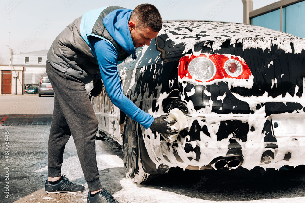 The man washing his car on self-service car wash. Express Car Wash ...
