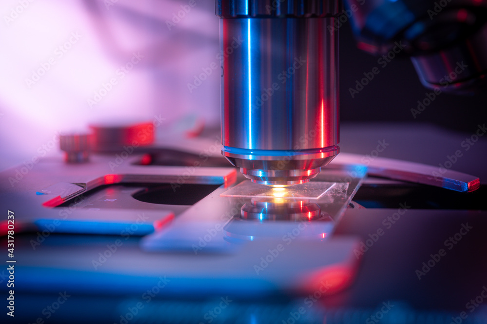 Toned photo of a backlit microscope lens in a science laboratory Stock ...