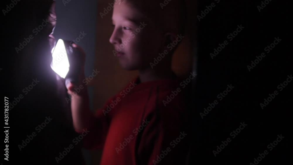 boy playing with light at night,little boy hiding in the wardrobe at ...