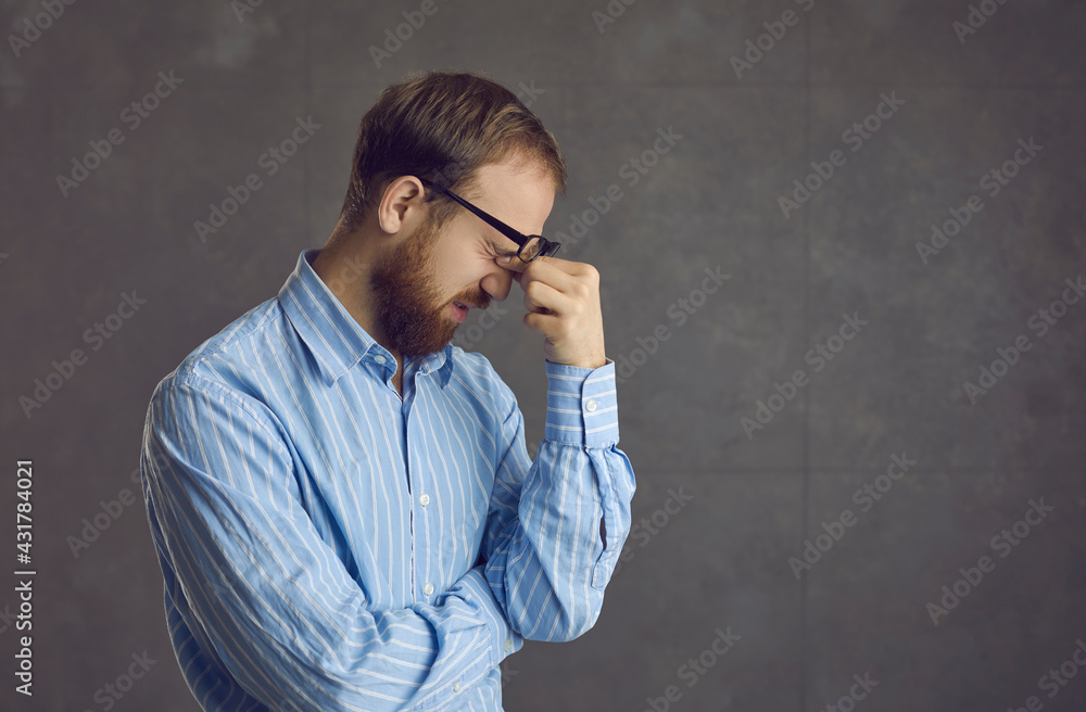 Side profile view studio shot of tired young man suffering from ...
