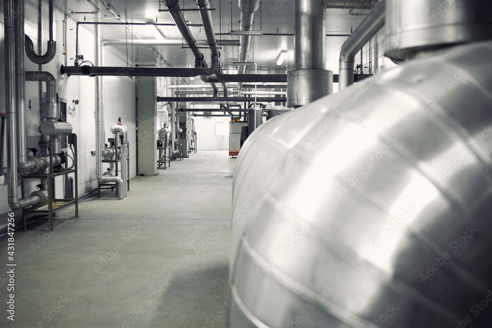 Interior view of boiler room or heating plant with pipes and pressure ...