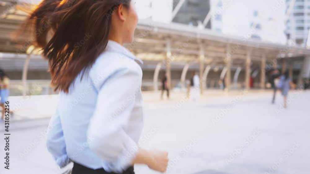 Late young Asian business woman rushing for work and running towards ...
