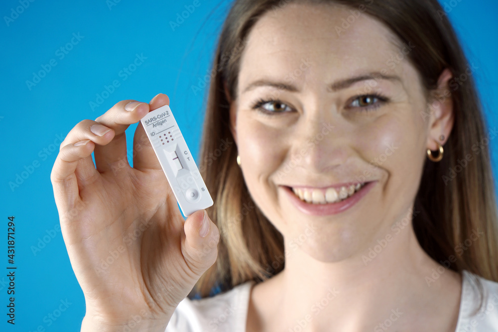 Lucky woman as a patient showing antigen self test card with negative ...