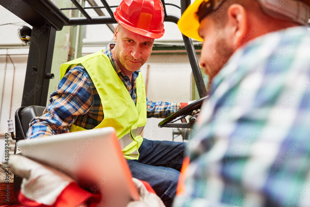 Forklift driver and warehouse clerk at the forklift Stock Photo | Adobe ...