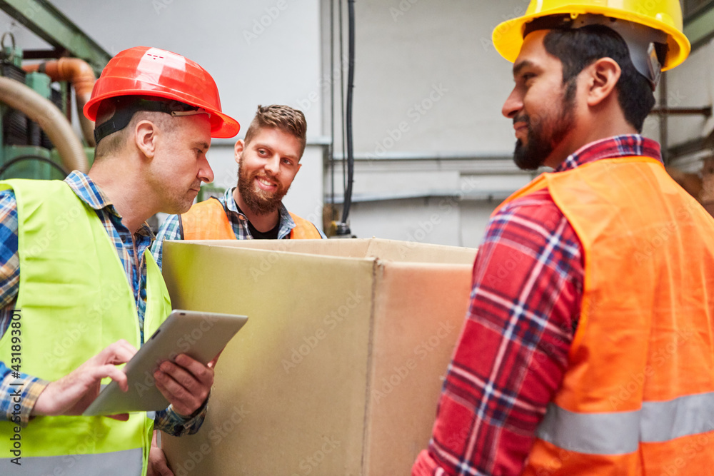 Order picker with tablet computer checks cardboard box Stock Photo ...