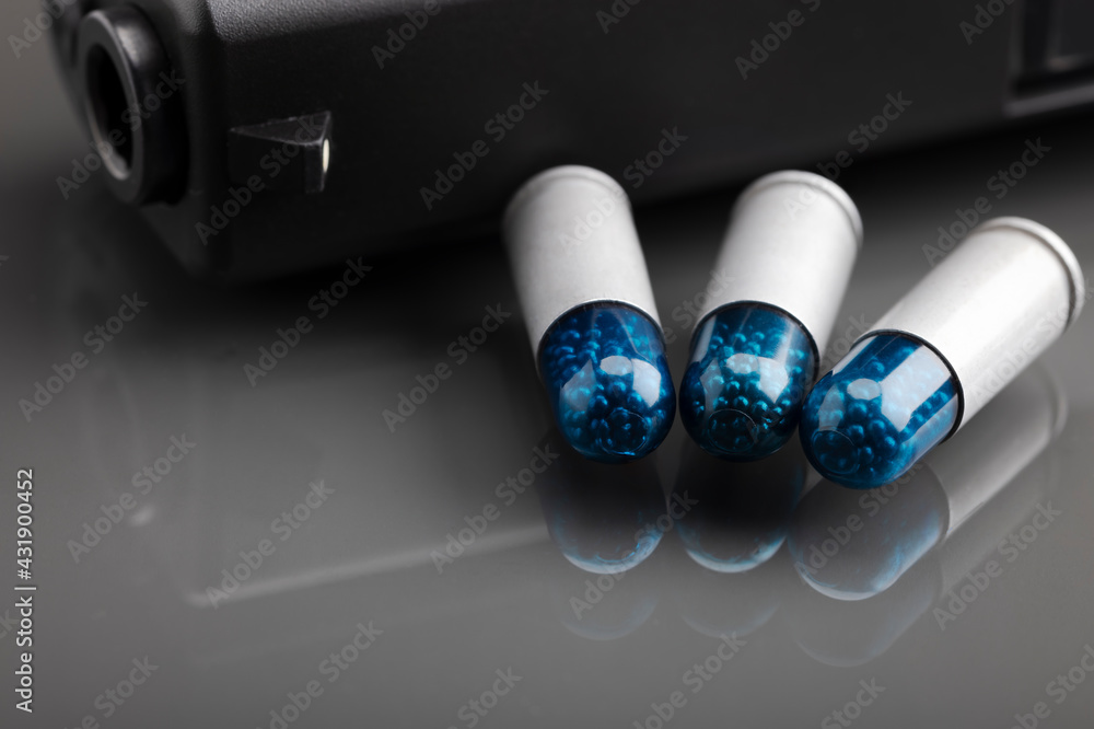 9 mm. Shotshells or birdshot ammunition with pistol gun background ...