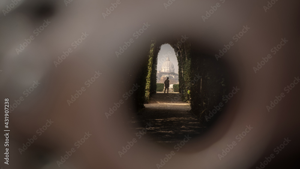 The dome of Saint Peter Basilica and a walking man seen through the ...