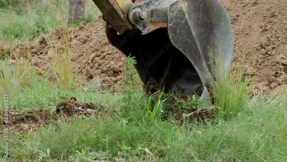 Excavator working in a field of a Farm. Backhoe operating in a Land on ...