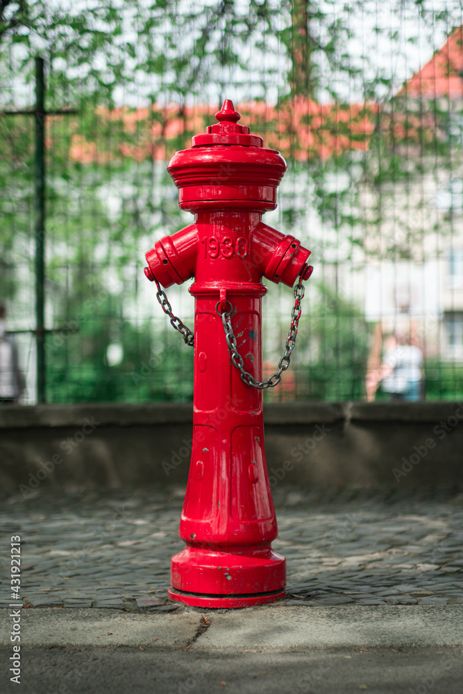 An old red fire hydrant from 1930 on a city street. Stock Photo | Adobe ...