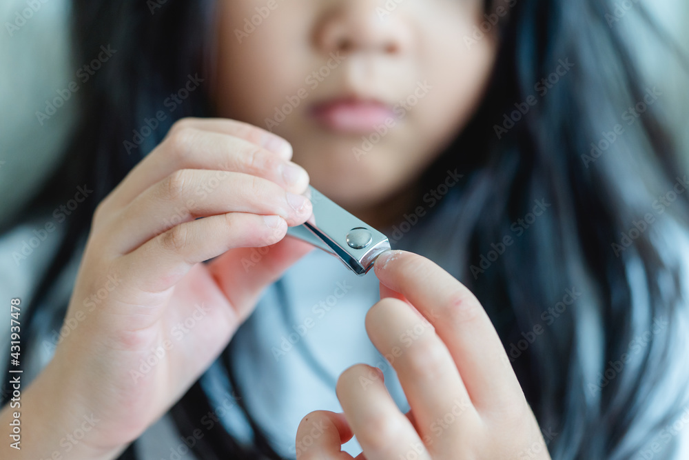 clean nails.kid child girl cutting nails using stainless steel nail ...