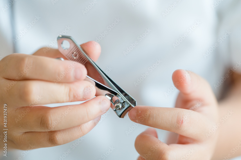 clean nails.kid child girl cutting nails using stainless steel nail ...