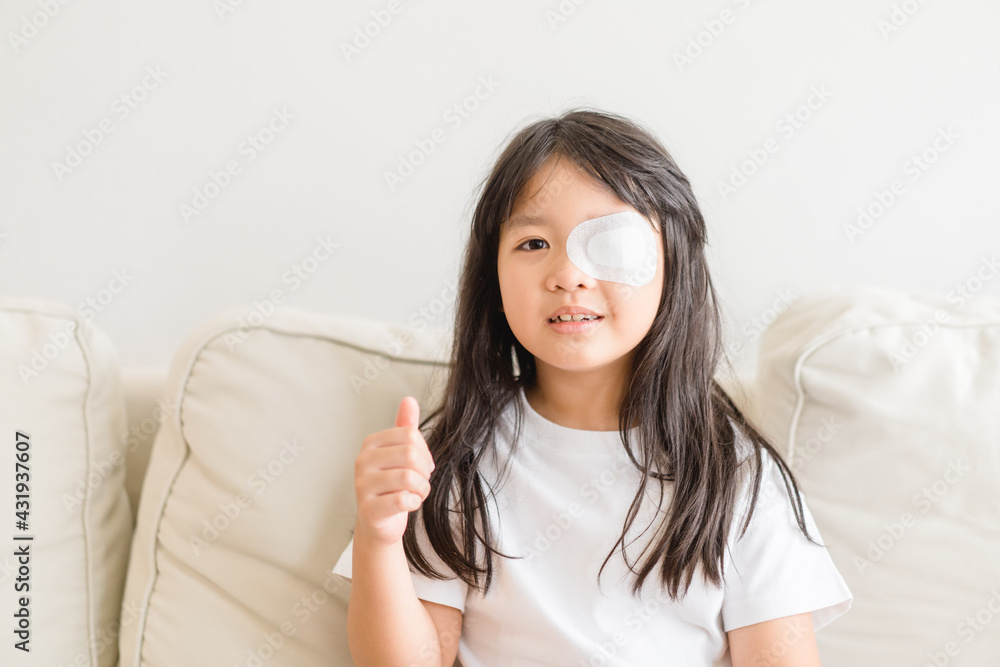 Lazy Eye amblyopia in children.Eye care.Little asian girl covered up ...