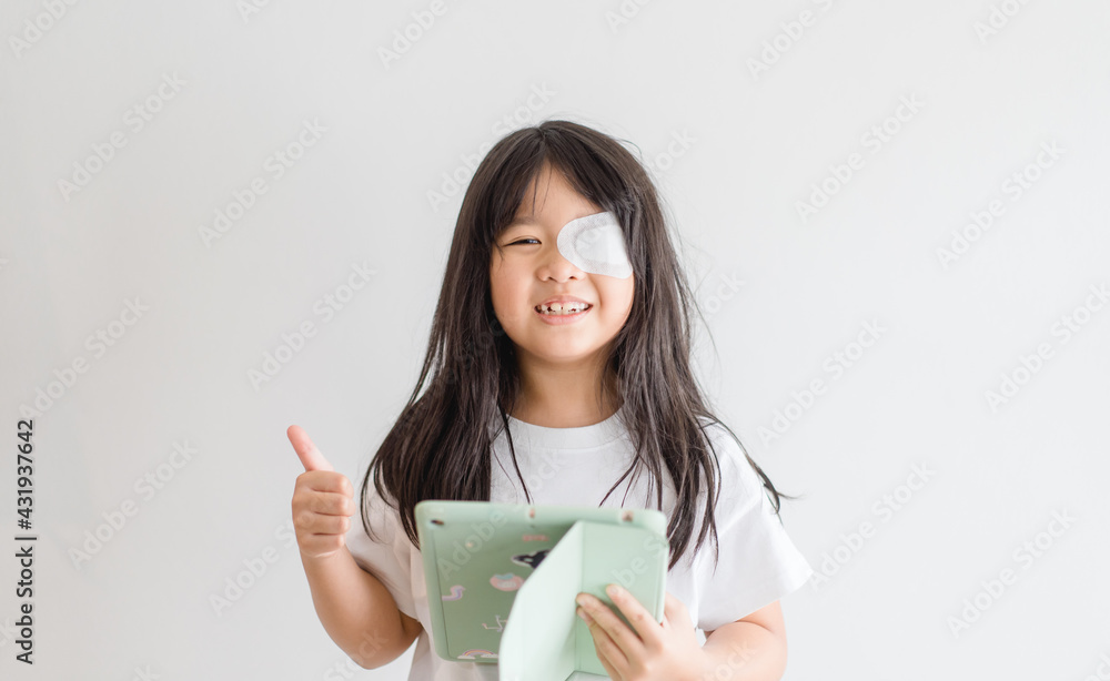 Lazy Eye amblyopia in children.Eye care.Little asian girl covered up ...