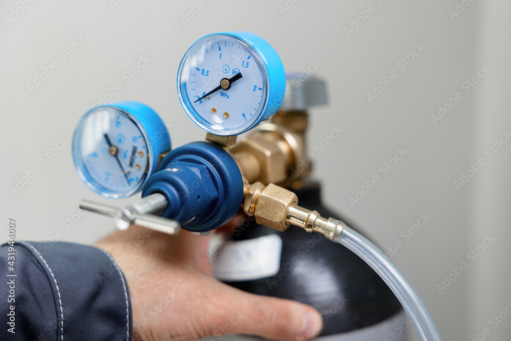 A metrology laboratory specialist takes a compressed gas cylinder for ...