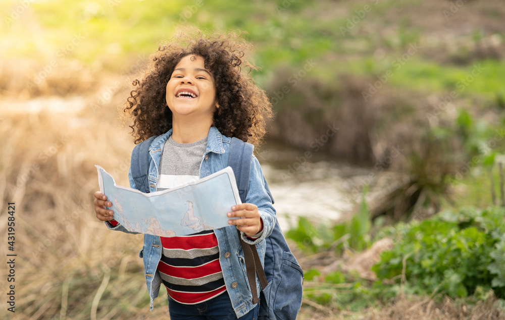Cheerful boy holding map in nature Stock Photo | Adobe Stock