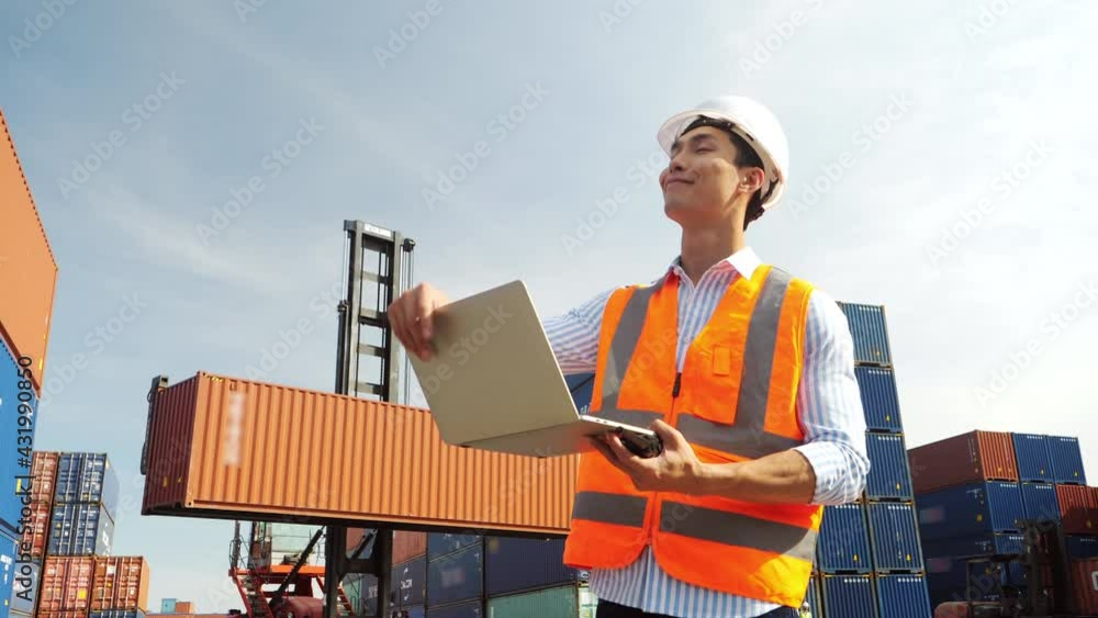 Front view of Mechanical engineer using walkie-talkie in Container ...