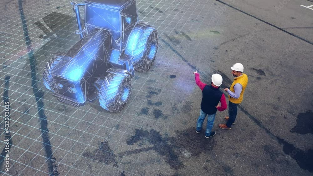 Two workers discuss a project of the new tractor using futuristic ...