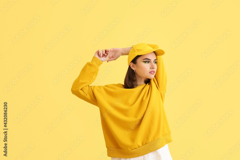 Stylish young woman on yellow background Stock Photo | Adobe Stock
