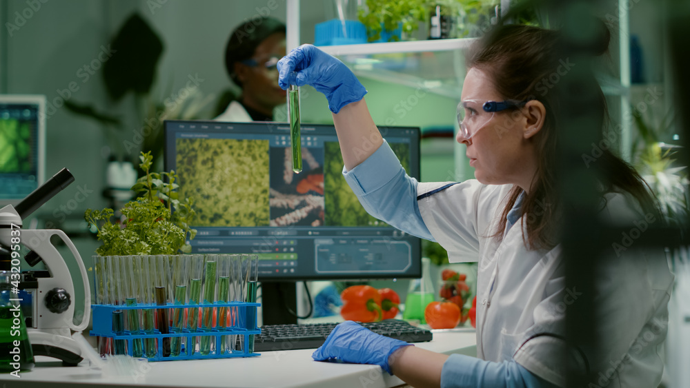 Biochemistry doctor examining chemical test under microscope for ...