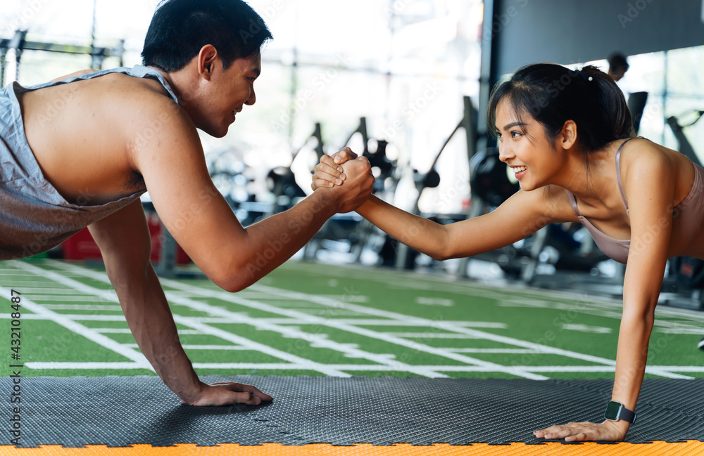 Healthy smiling couple of man and woman giving high five to each other ...