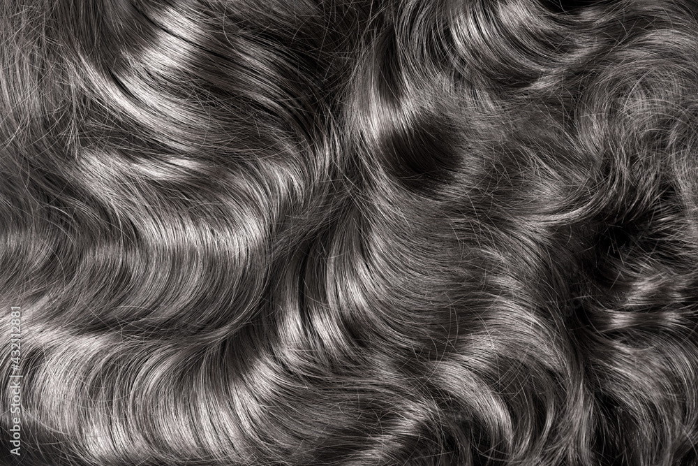 Black hair texture. Wavy long curly dark hair close up as background ...