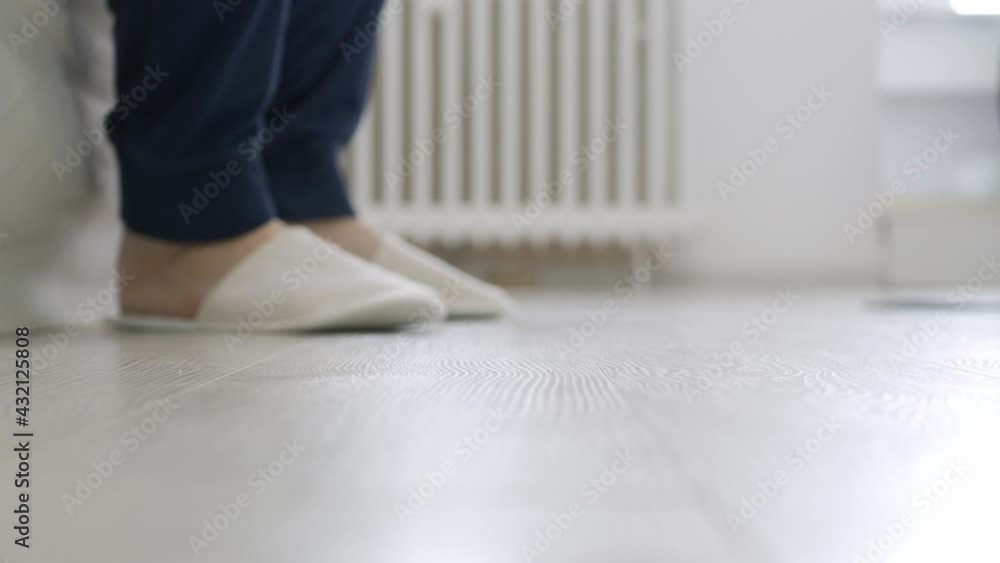Adult Person Comes in the Bedroom, Takes Off His Slippers, Puts the ...