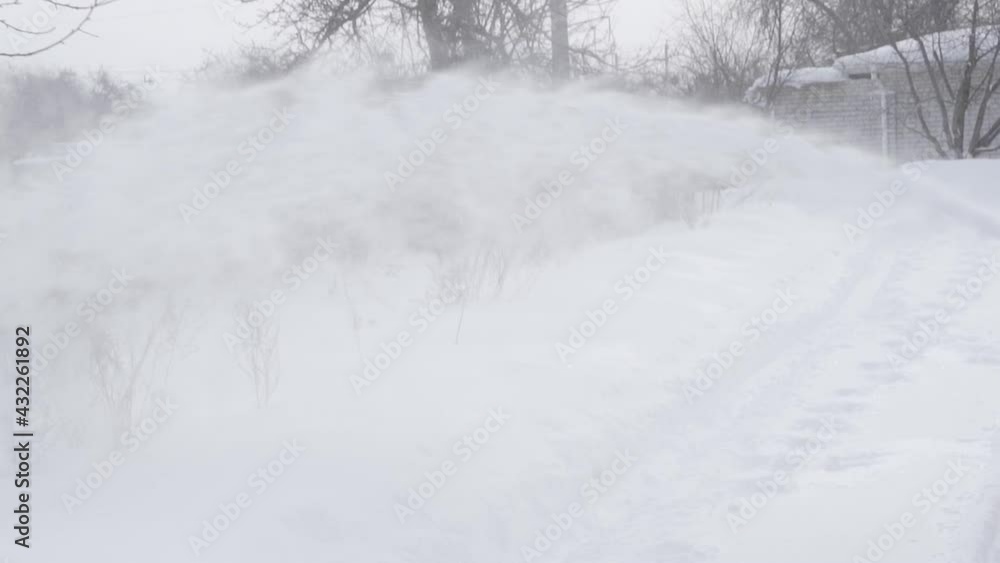 Large amounts of snow are blown out through the drawbar of the ...