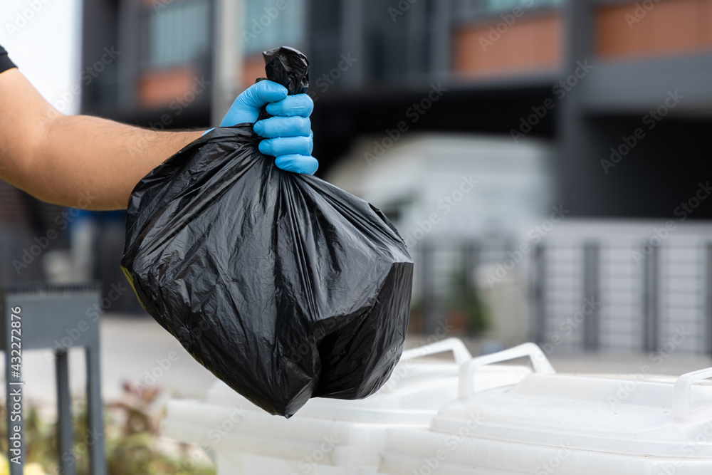 The young man separated the dangerous waste into a large black bag and ...