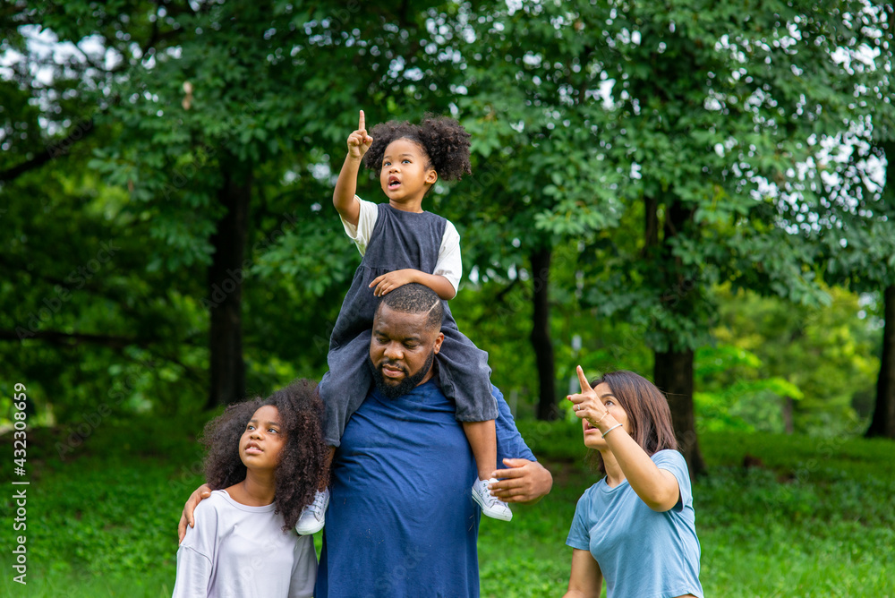 Happy mixed race family African father and Asian mother with two little ...