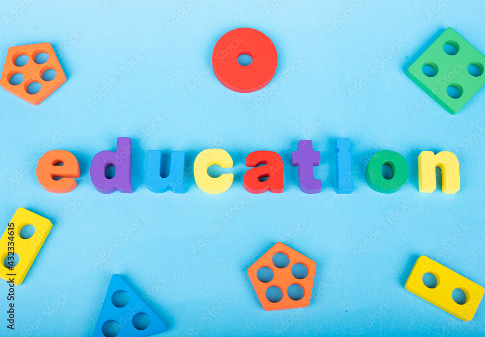 Education word written with wooden alphabets blocks on blue chart kids ...