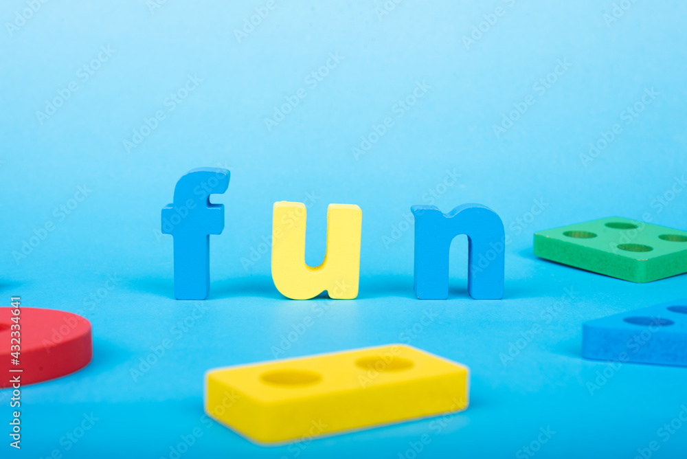 Fun word written with wooden alphabets blocks on blue chart kids ...