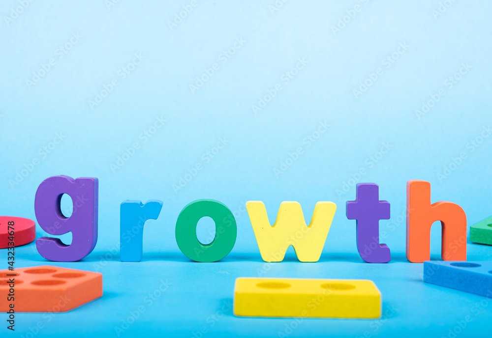 Growth word written with wooden alphabets blocks on blue chart kids ...