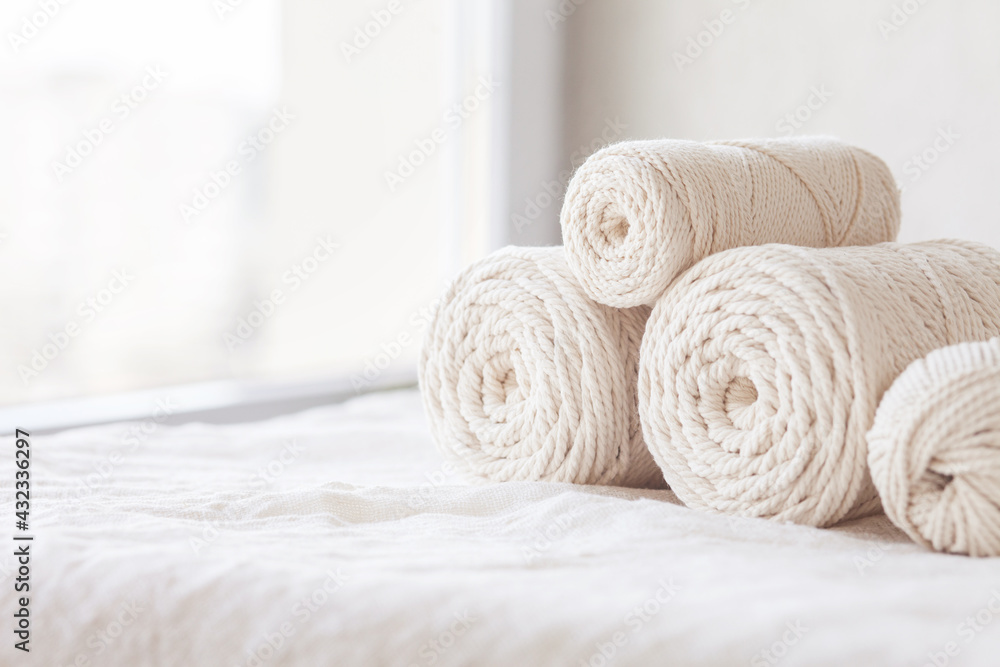 Handmade macrame braiding and cotton threads on white background. Light ...