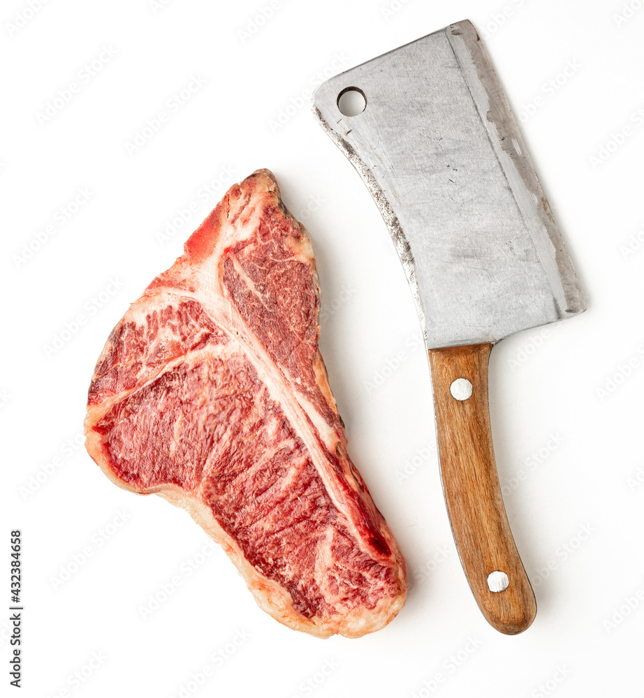 Raw beef steak on the bone with an ax on a white background. Top view ...