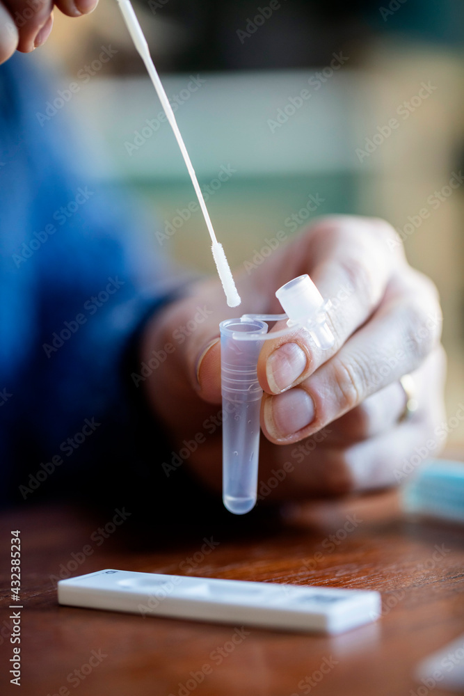 Close up of a person using coronavirus covid-19 rapid antigen home ...