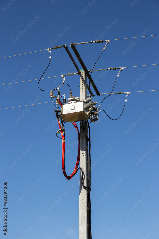 Electrical pylon with high voltage transformer on blue sky Stock Photo ...
