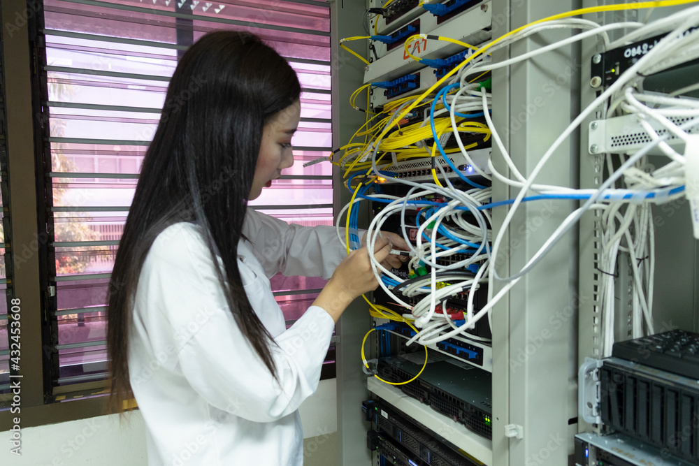The system administrator works in the server room of the data center ...
