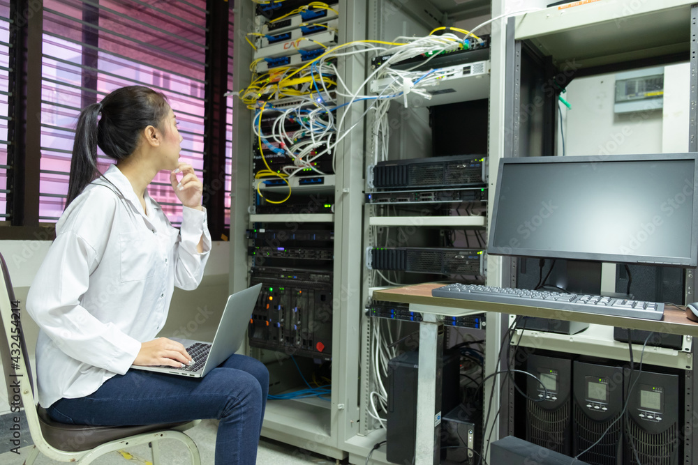 The system administrator works in the server room of the data center ...