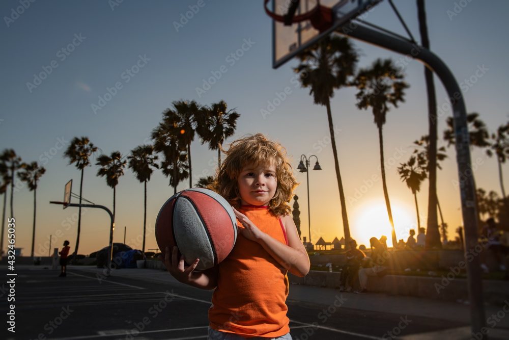 Basketball kids game. Cute little boy holding a basketball ball trying ...