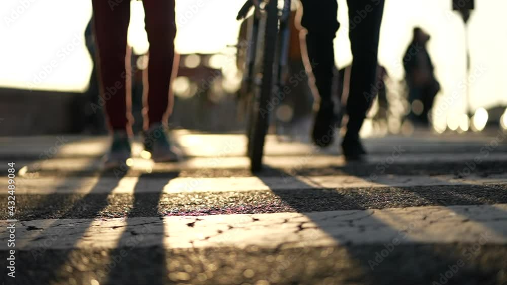 Blurred pedestrians crossing street, person dragging bicycle Stock ...