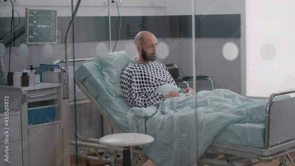 Stressed sick man sitting in bed waiting for respiratory treatment ...