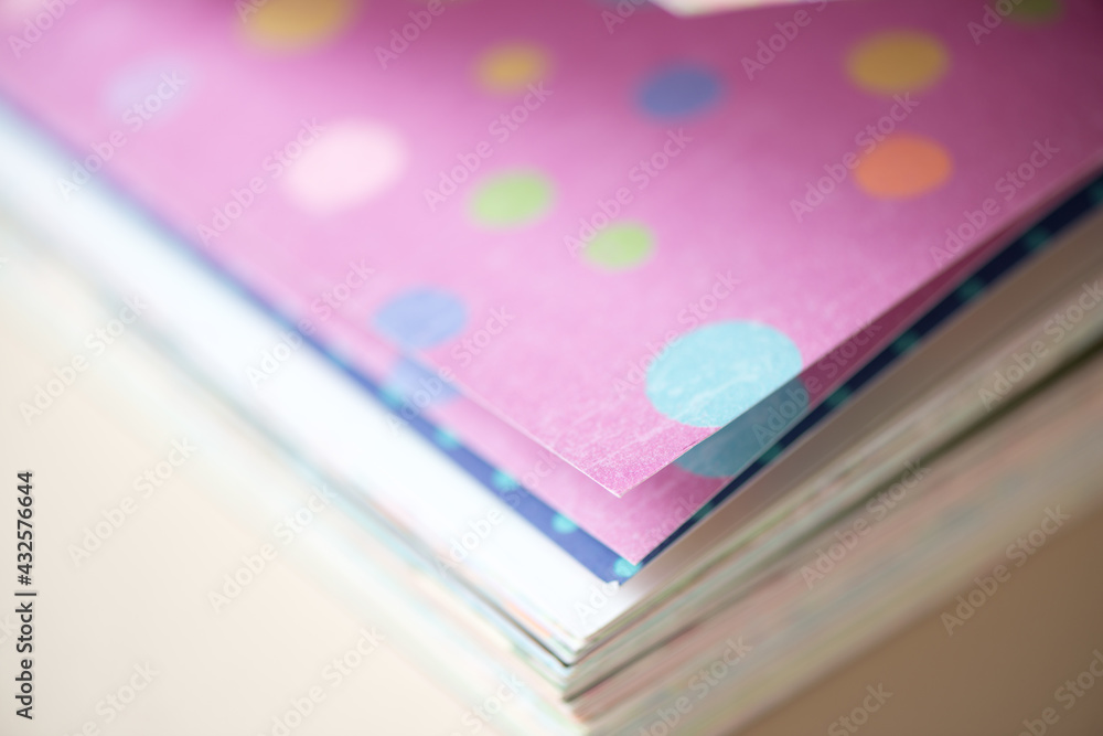 stack of pink scrapbooking paper with large circles photographed using ...
