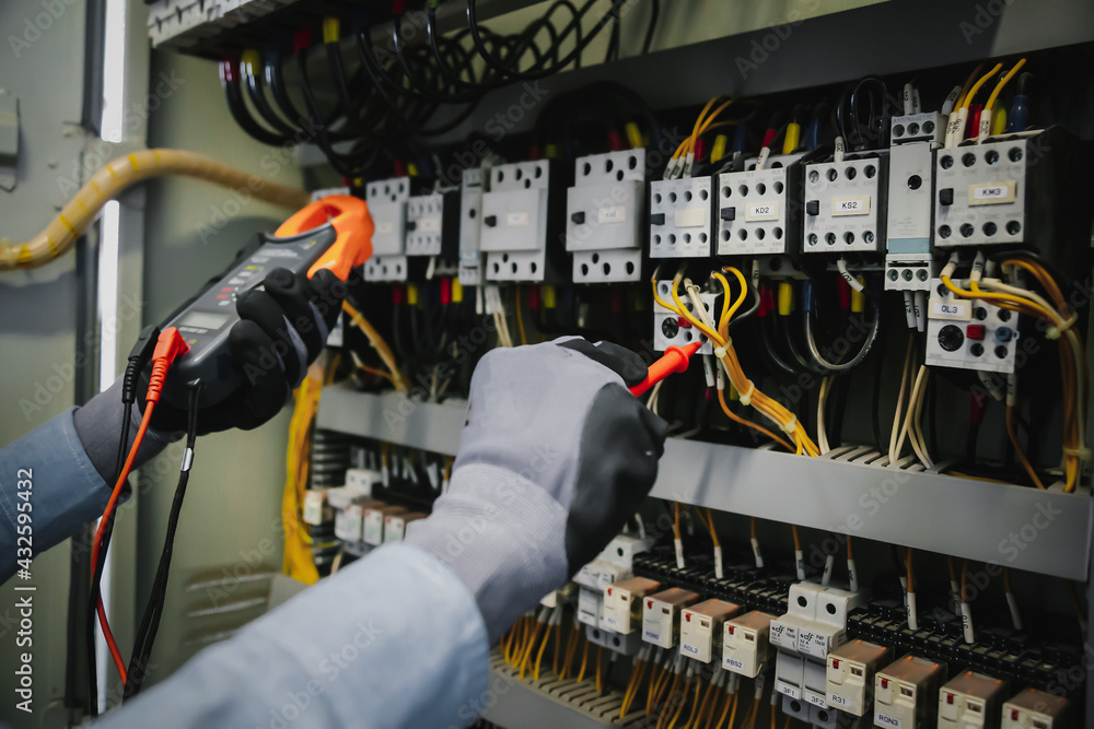 Fotka „Electrical engineers test electrical installations and wiring on ...