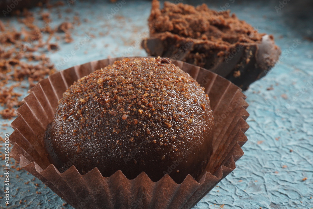 Chocolate petit fours on a table. Chocolate petit four sweets with ...