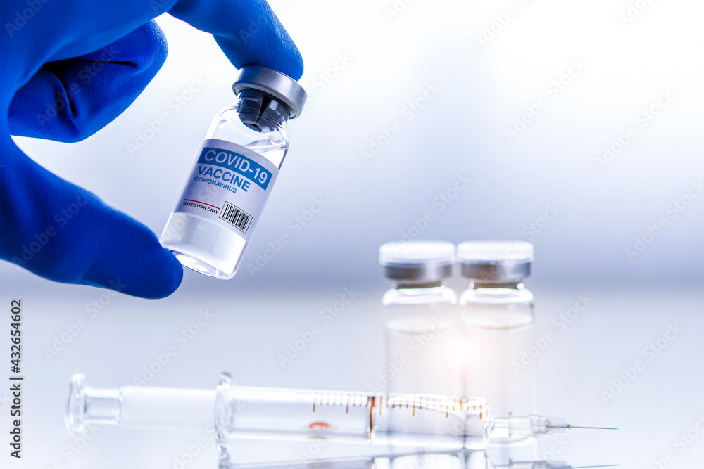 Hand of doctor holding vaccine coronavirus bottle development vial dose ...