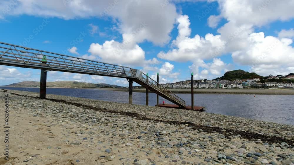 Floating dock harbour elevated walkway platform on Llandudno beach ...