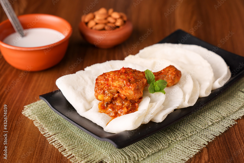 Rice pathiri Pathiri flat bread with spicy chicken leg curry, coconut ...