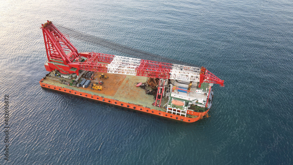 Top view of a barge equipped with a powerful crane currently in rest ...