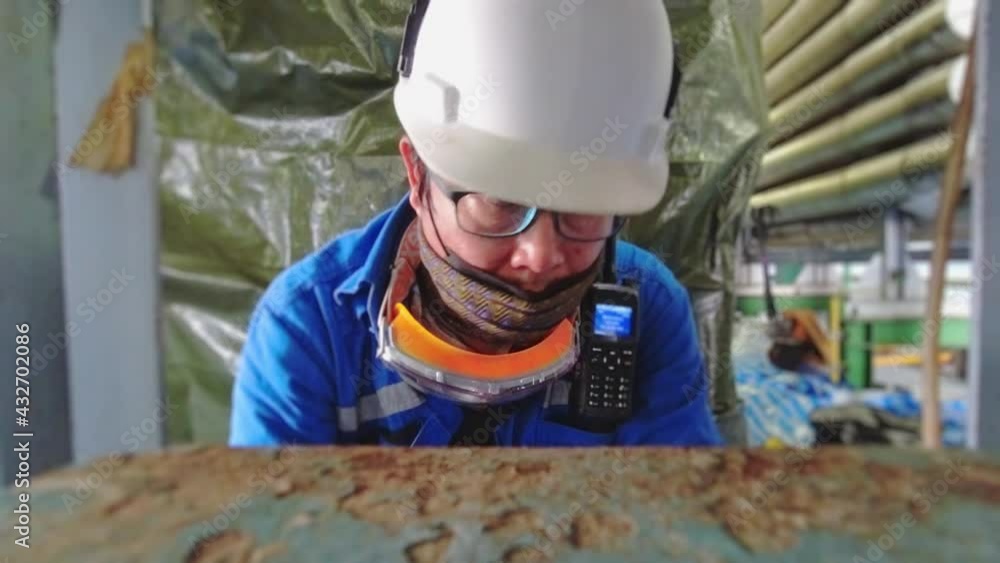 Portrait of industrial worker working in a factory, He is wearing a ...